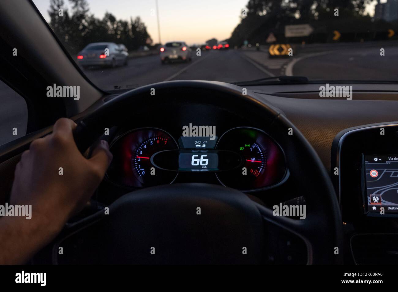 Driver view to the speedometer at 66 kmh or 66 mph on a high traffic ...
