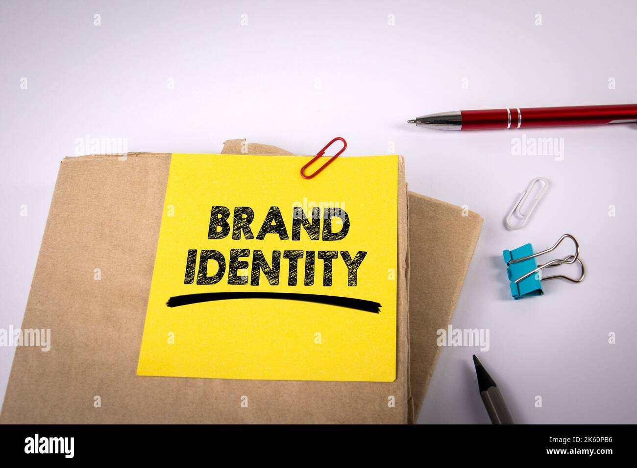 Brand Identity. Stack of books with text on a yellow sheet of paper ...