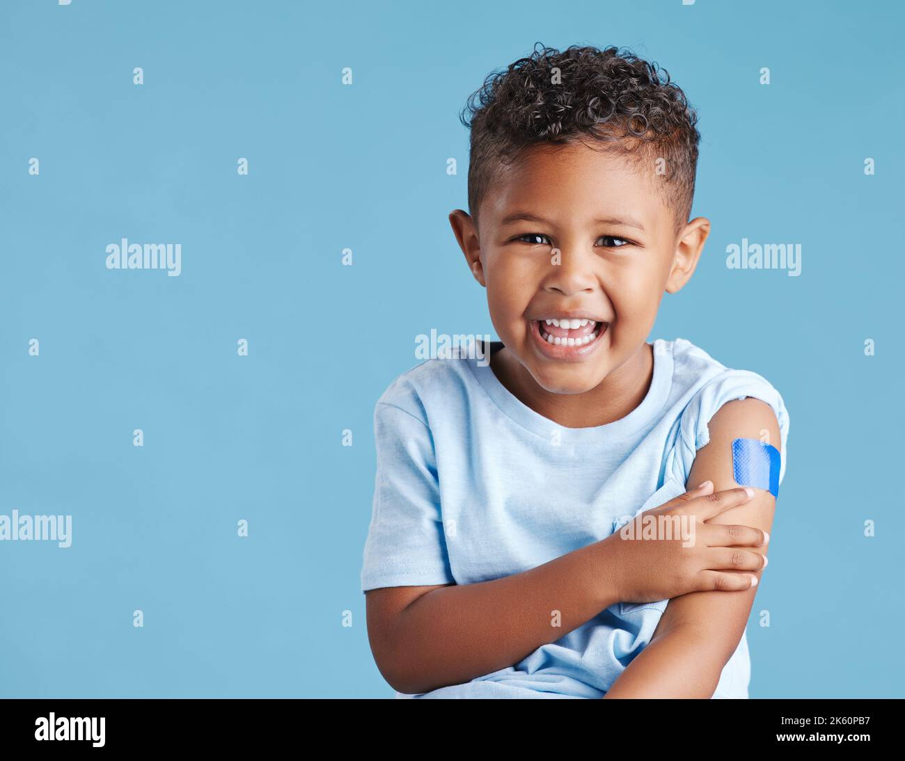 Happy vaccinated boy kid showing arm with adhesive bandage after ...