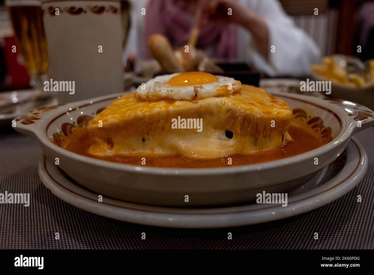 Francesinha (French Sandwich) with fried egg on top. Is a typical food ...