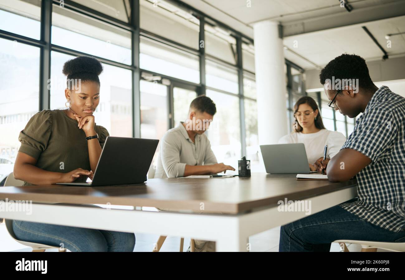 Diverse group of entrepreneurs business people working on laptops and ...