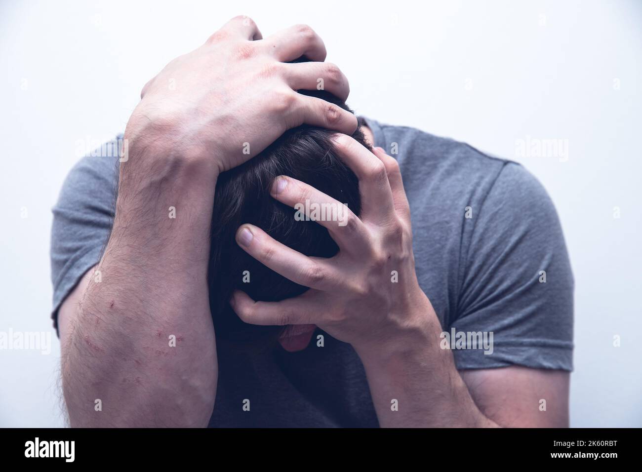 A male covering his head by hands isolated on white background, Health ...