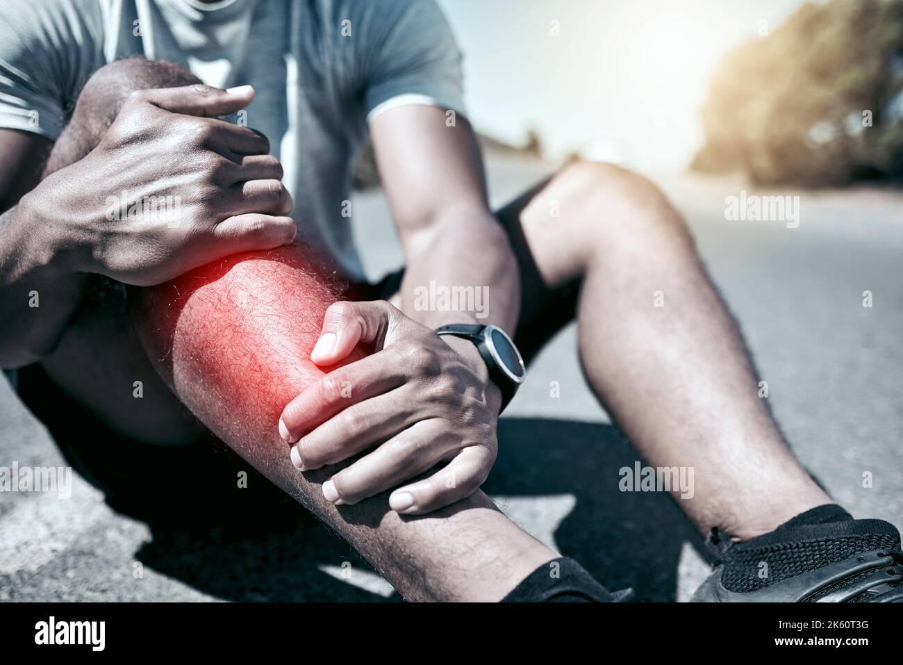 Closeup fit mixed race man holding his leg in pain while exercising ...