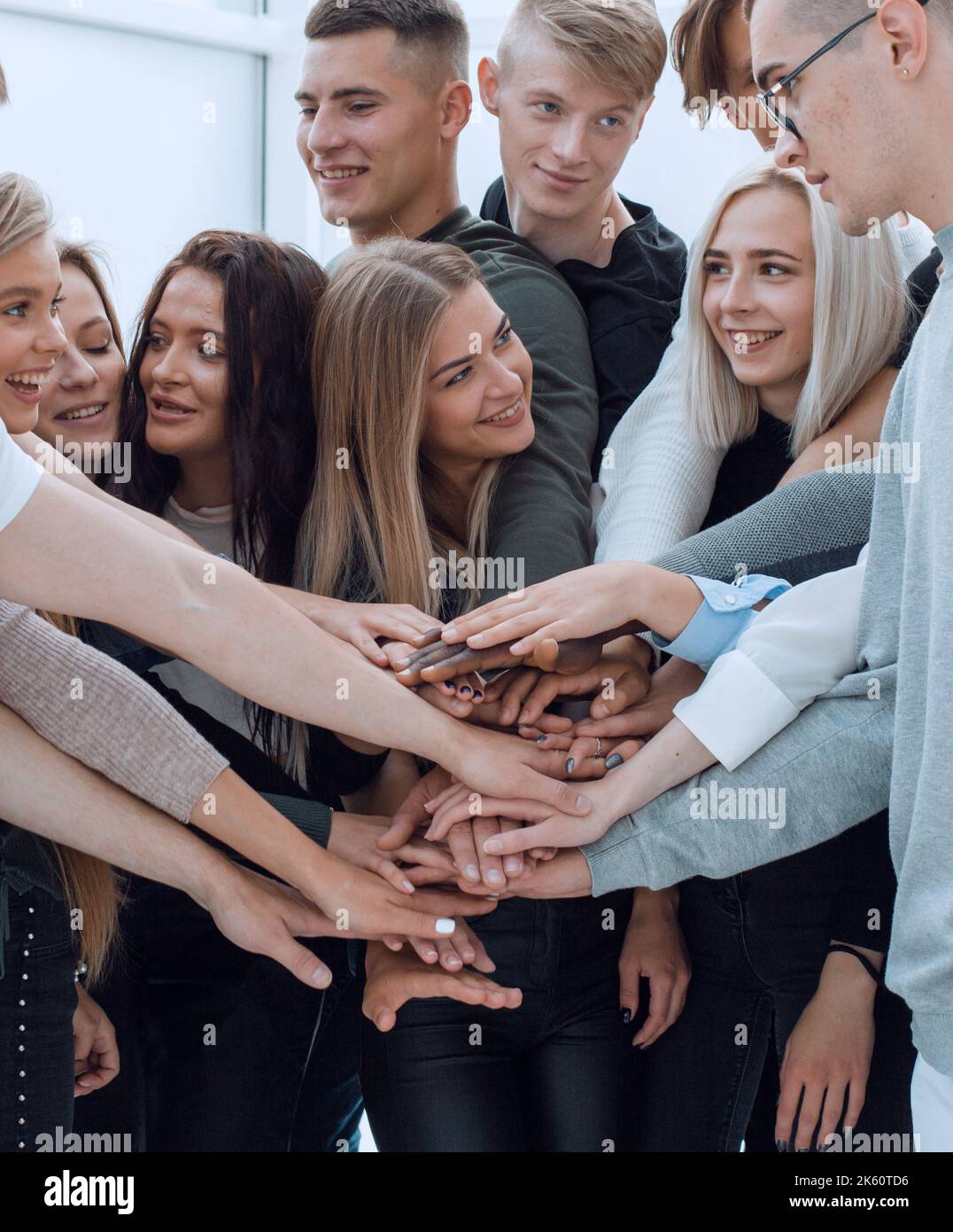 large group of young people joining their hands together Stock Photo - Alamy