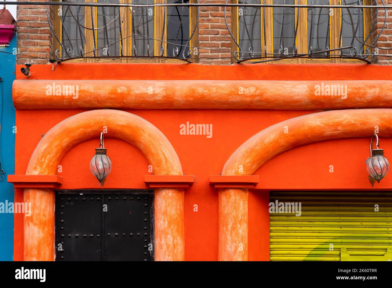 Bright orange building facade with lamps. Traditional Mexican colorful ...