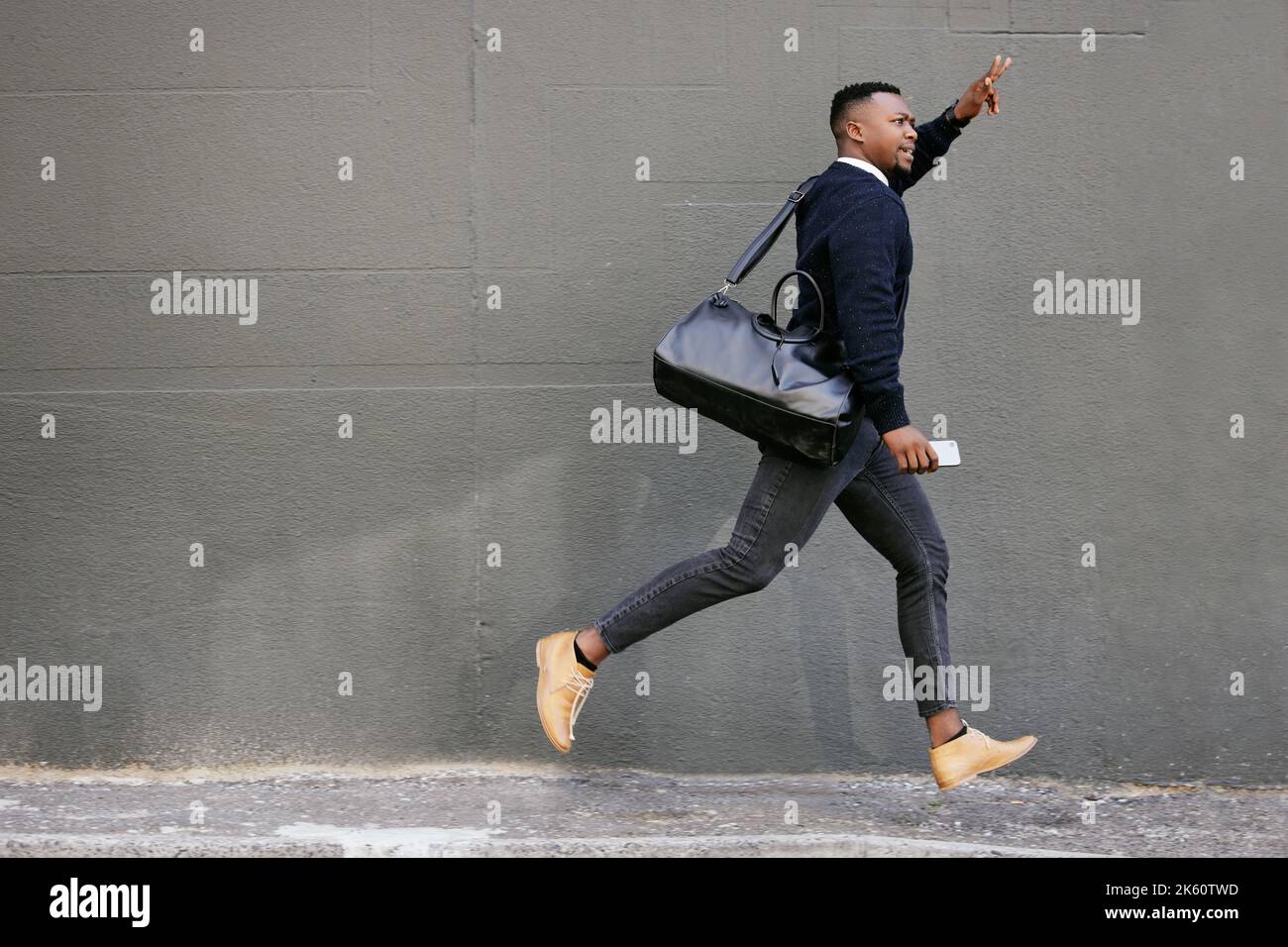 African american businessman travelling alone and rushing for a taxi in ...