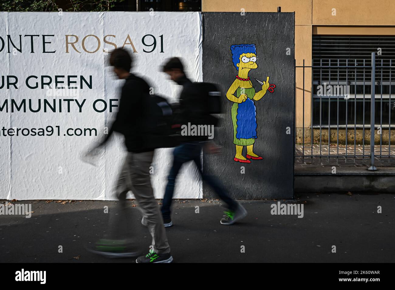 Milan, Italy on October 11, 2022, People walk past a mural entitled ...