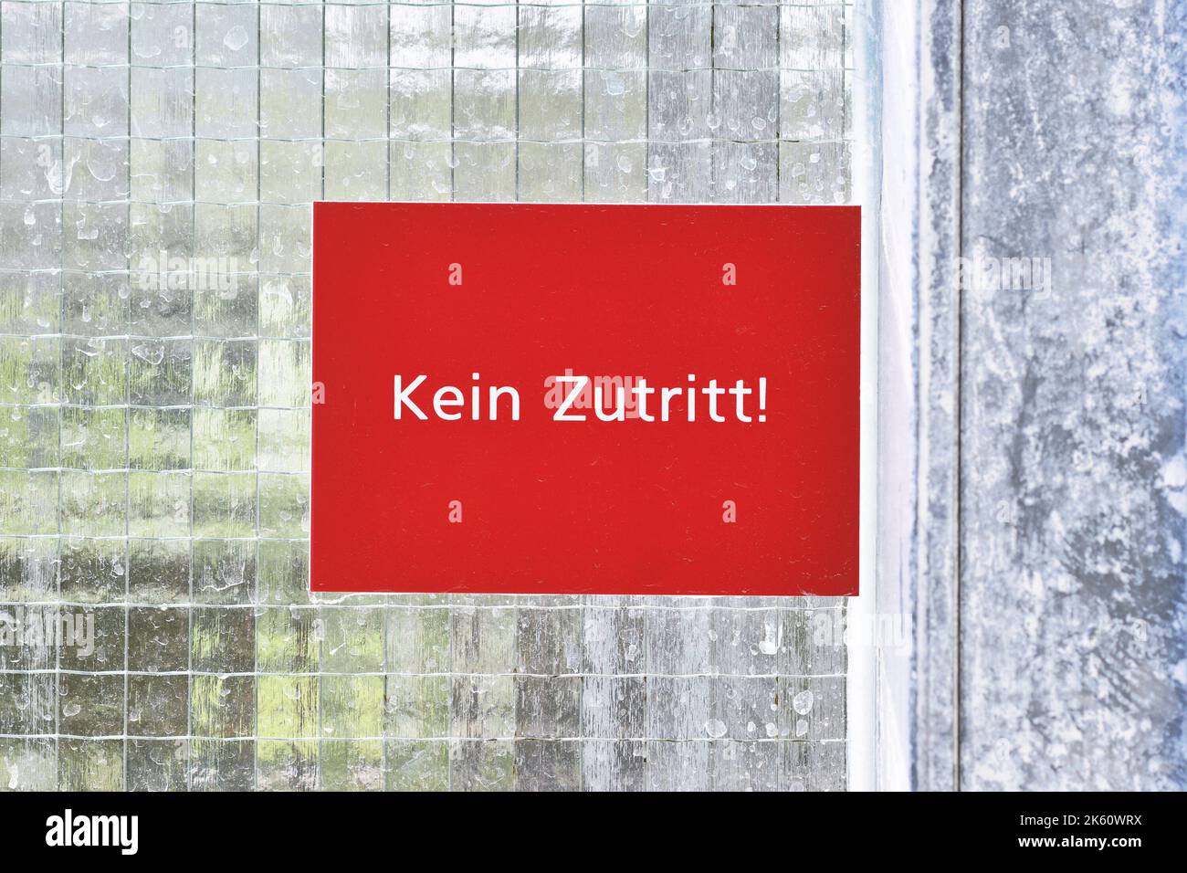 Red sign at door with German text 'Kein Zutritt' (Translation: 'No ...