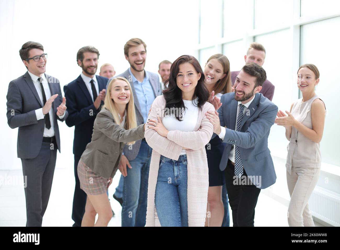 happy business team admiring their young leader Stock Photo - Alamy