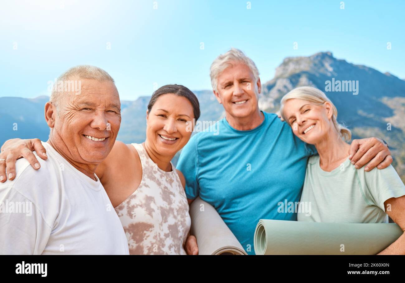 Portrait of a group of senior friends standing together at yoga retreat ...