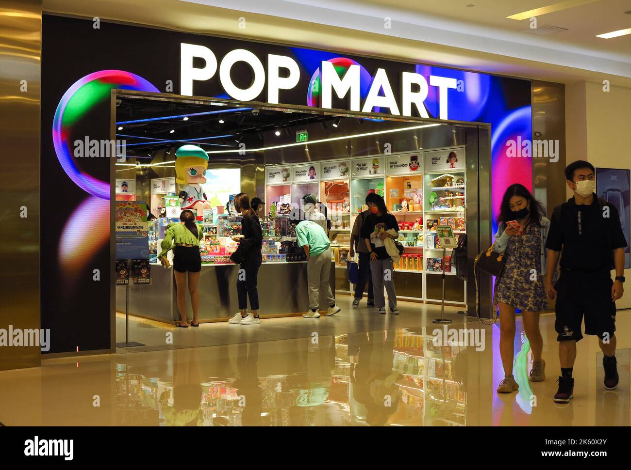 BEIJING, CHINA - AUGUST 28, 2022 - Customers pass in front of a POP ...