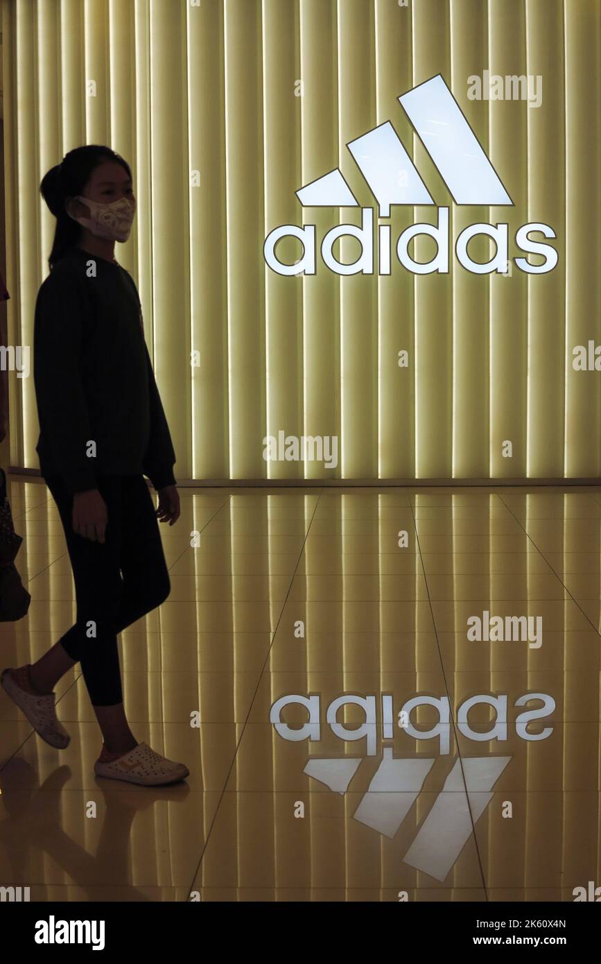 BEIJING, CHINA - AUGUST 28, 2022 - Customers pass in front of an adidas ...