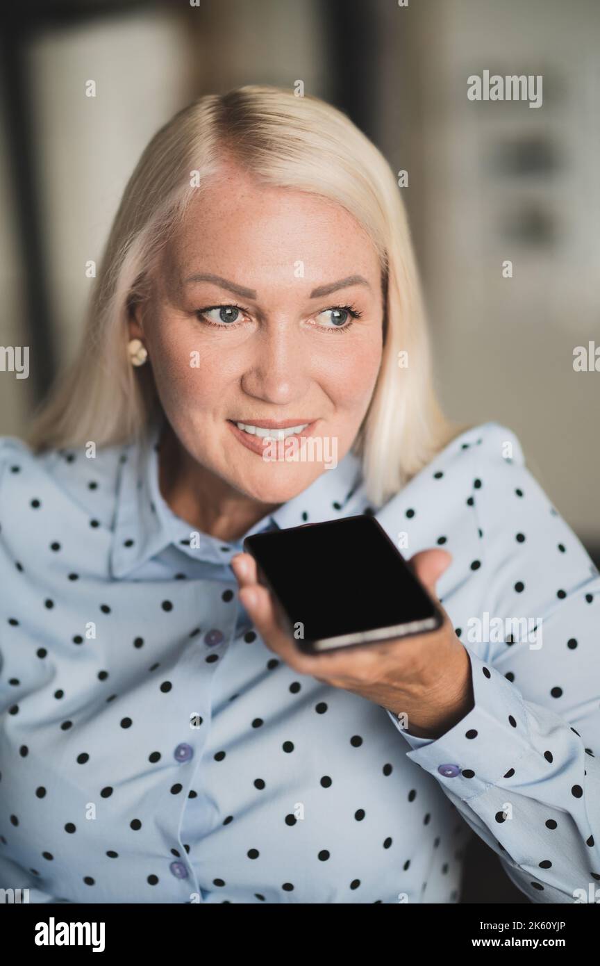 Joyous lady having a phone conversation indoors Stock Photo - Alamy