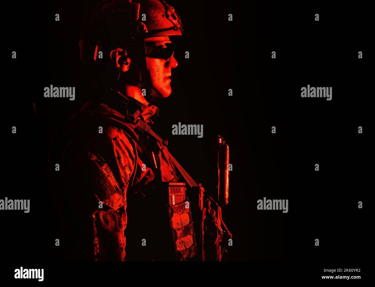 Half length low angle studio shot of special forces soldier in field ...