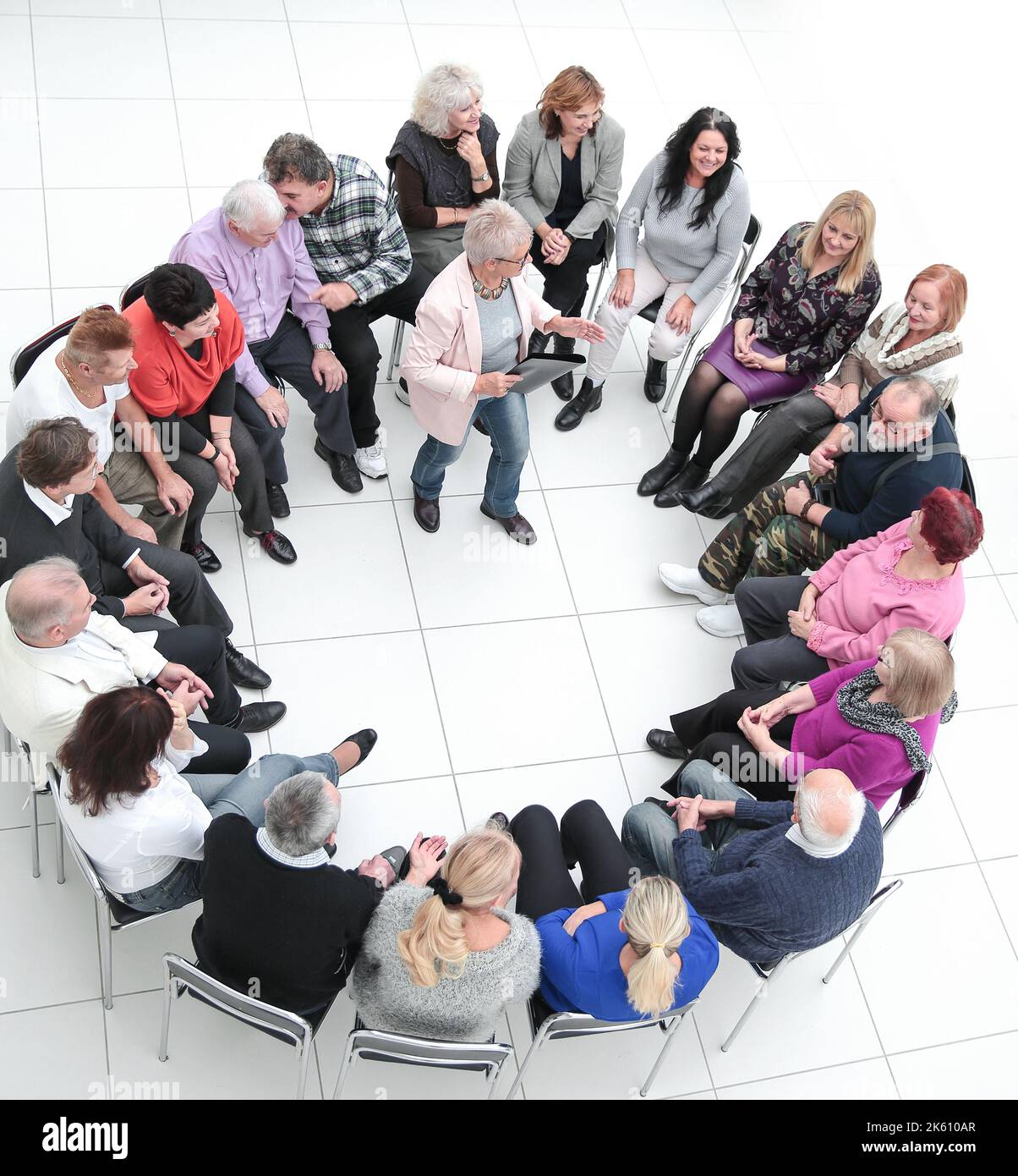 confident older woman standing in a circle of like-minded people Stock ...
