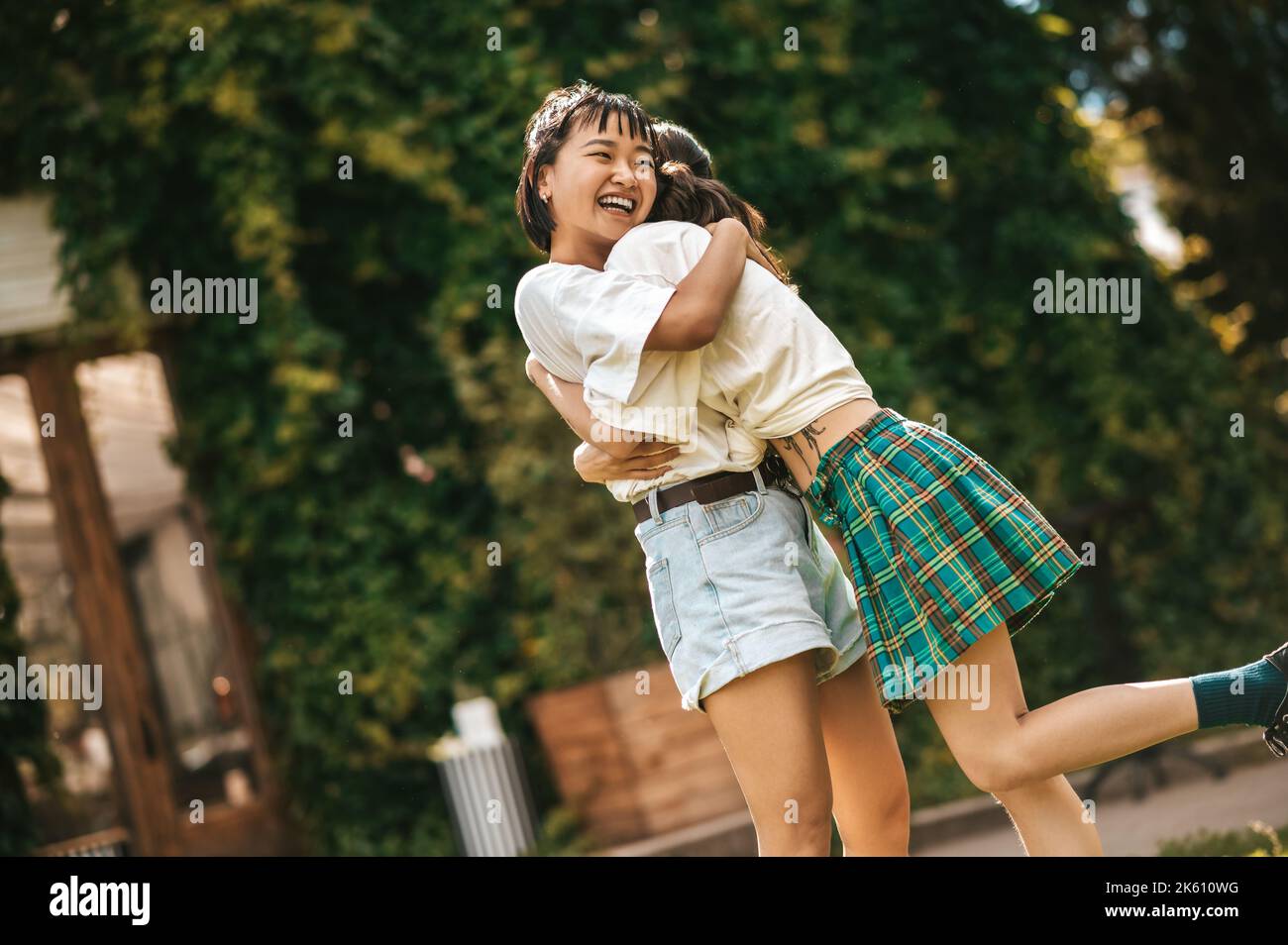 Cute girls hugging and feeling happy Stock Photo - Alamy