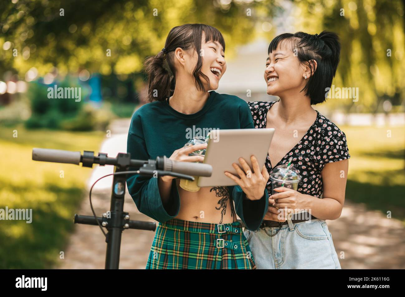 Two girls watching photos online and looking involved Stock Photo - Alamy