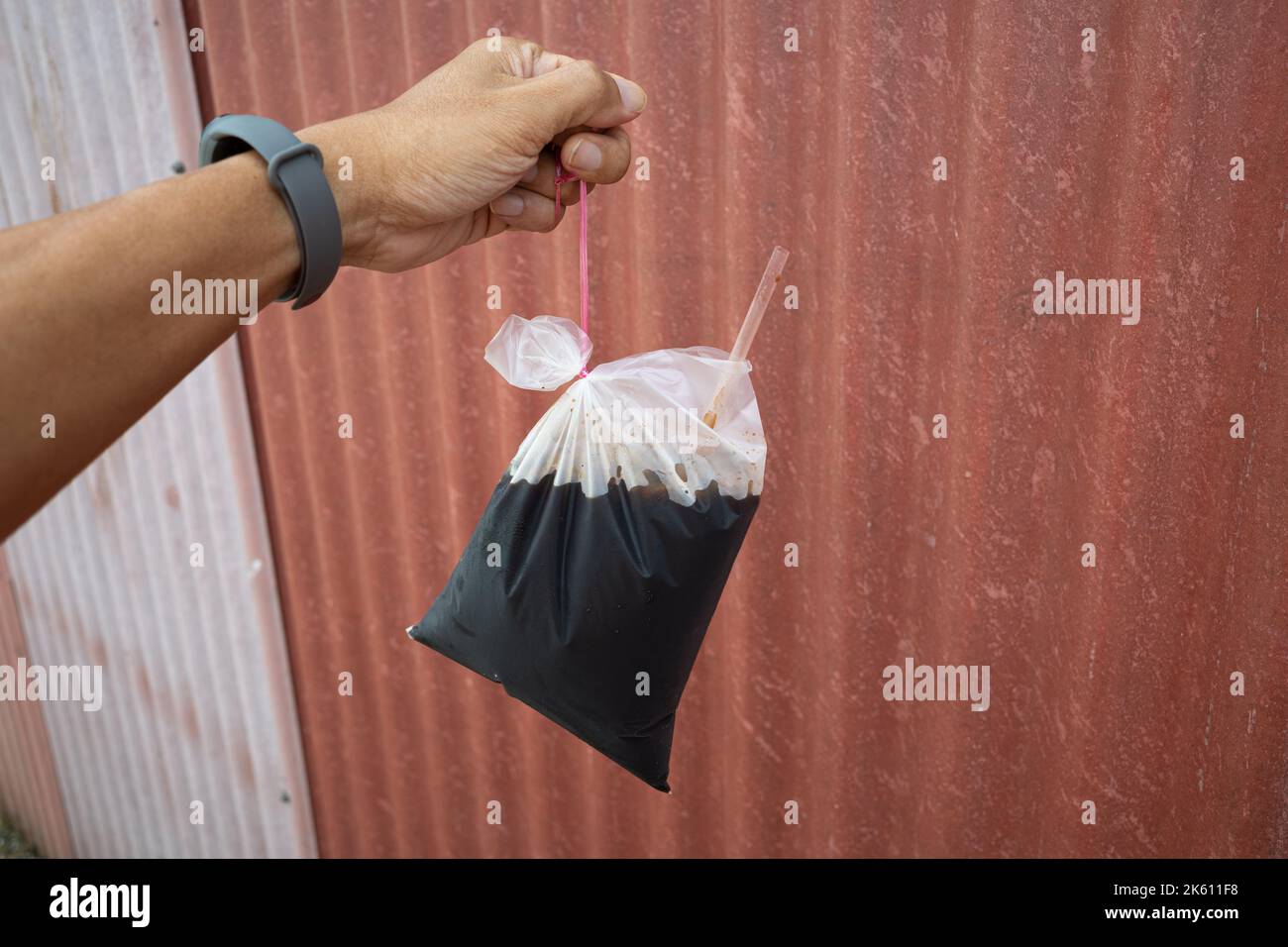 A Malaysian style take away black coffee drink in a plastic packet ...