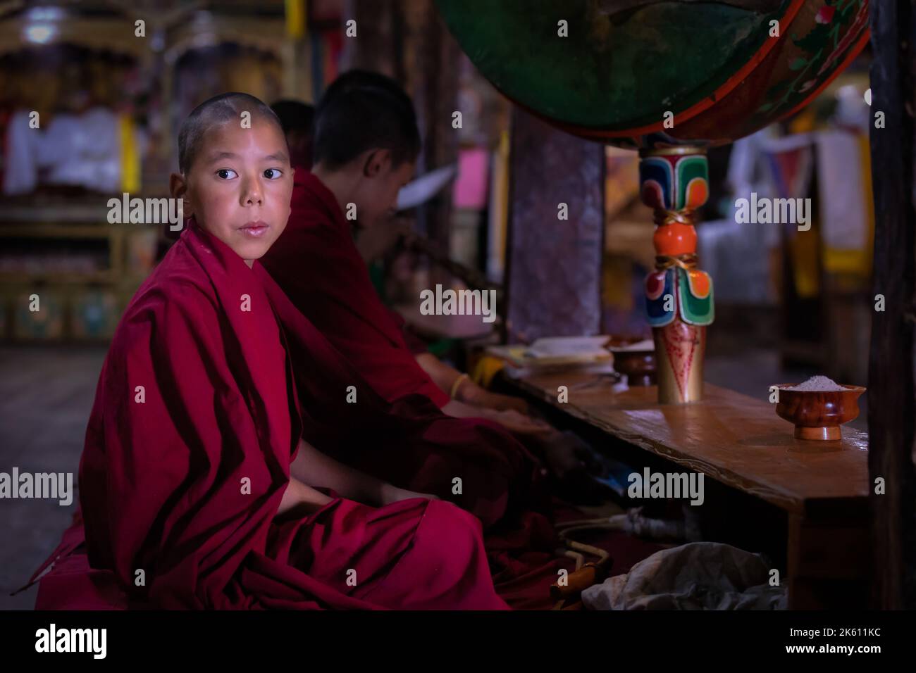 A young monk with a drum at Thikse Monastery (Gompa) during morning ...