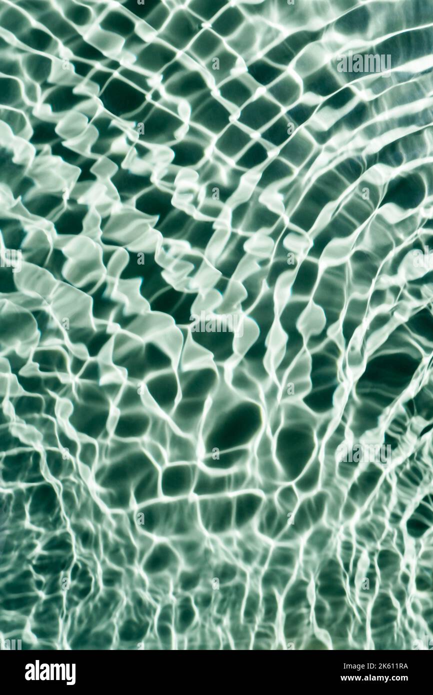 Rippled transparent fresh blue green water gel surface in swimming pool ...