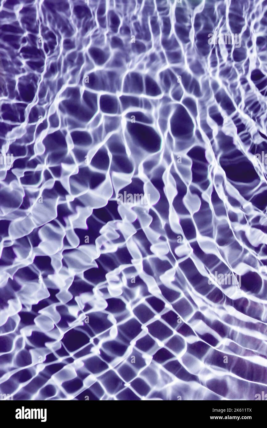 Rippled transparent fresh blue lilac water gel surface in swimming pool ...