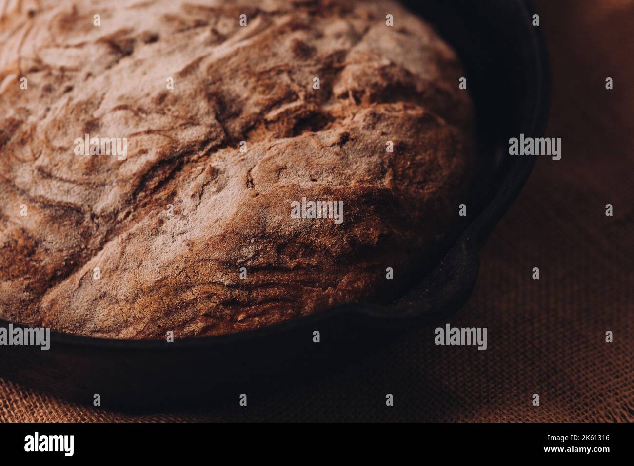 Crunchy freshly baked loaf of bread on the kitchen table Stock Photo ...