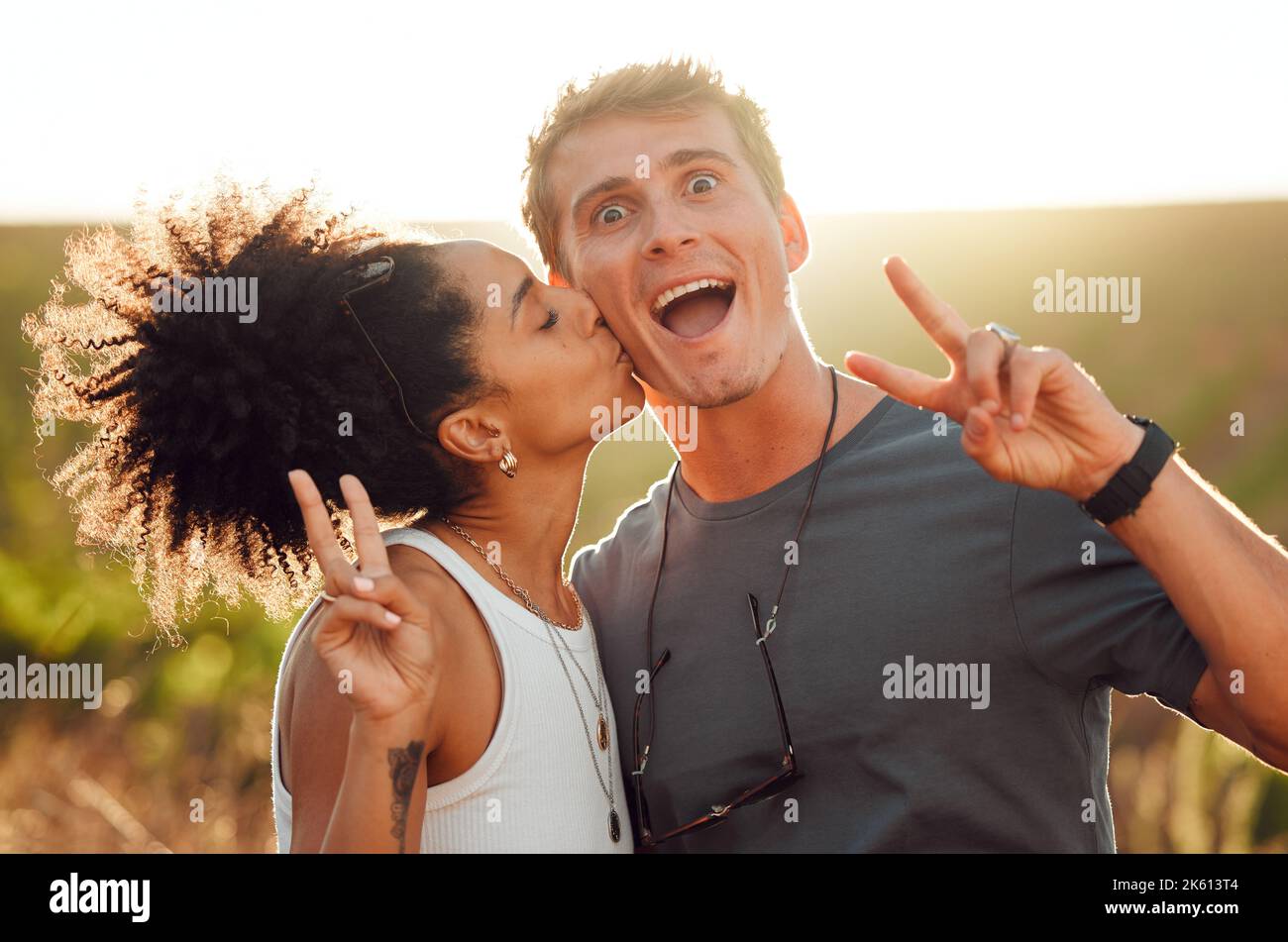 Funny, kiss and couple bonding during vacation on a farm with peace ...