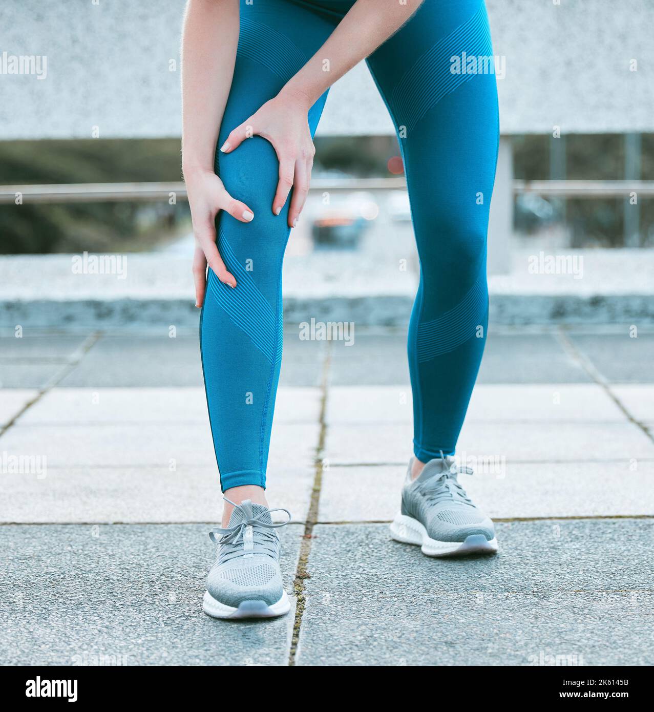 Closeup of one caucasian woman holding her sore knee while exercising ...