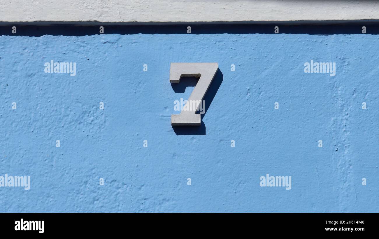 number seven in metallic plate format, with copy space and white color ...