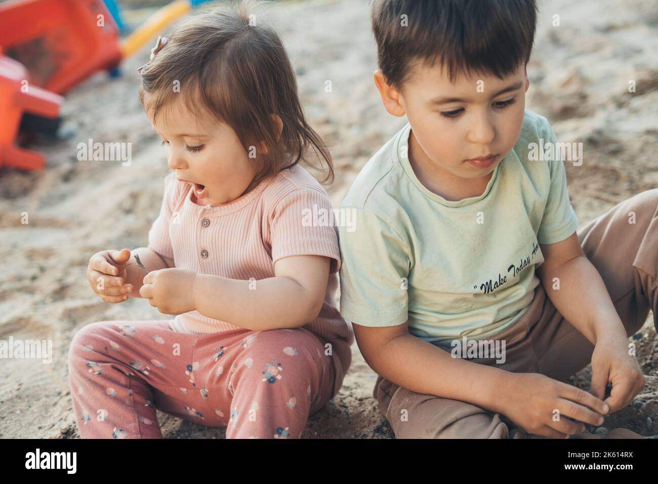 Enthusiastic kids playing at home sandbox together, enjoying leisure ...
