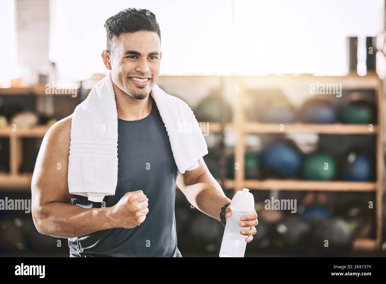 Happy trainer cheering in the gym. Fit, strong man taking a break from ...