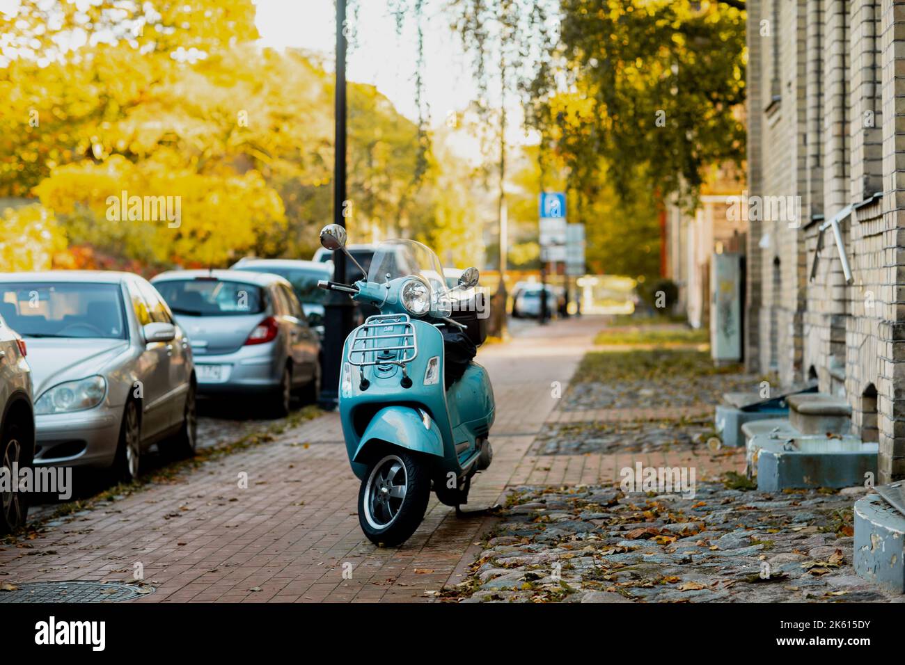 Oldschool turquoise colored vespa scooter on sidewalk Stock Photo - Alamy
