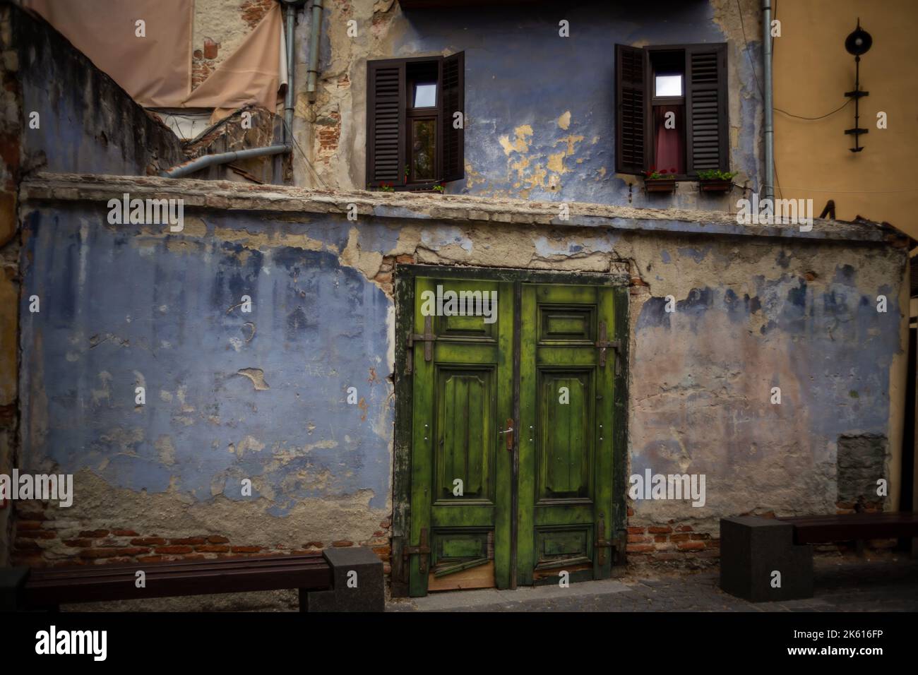 A beautiful shot of an old abandoned building with green wooden door ...