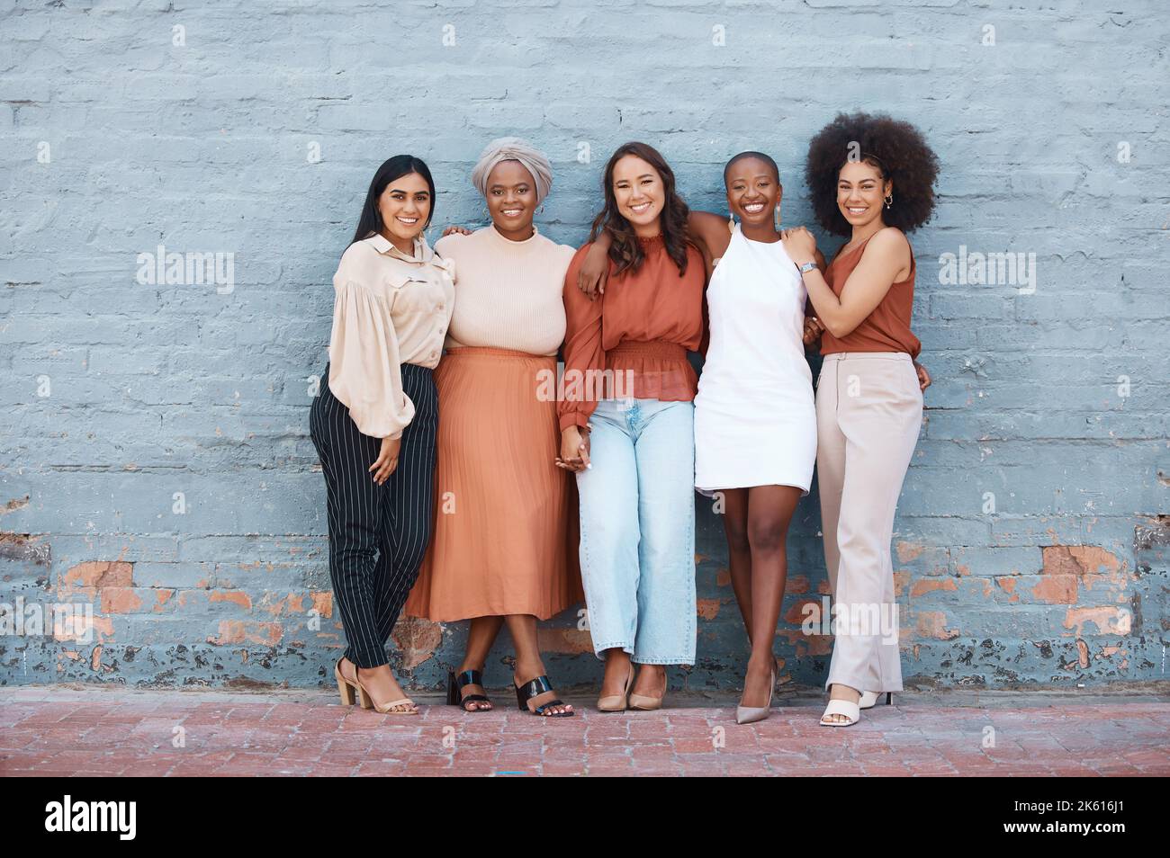Group of five young happy cheerful businesswomen hugging while standing ...