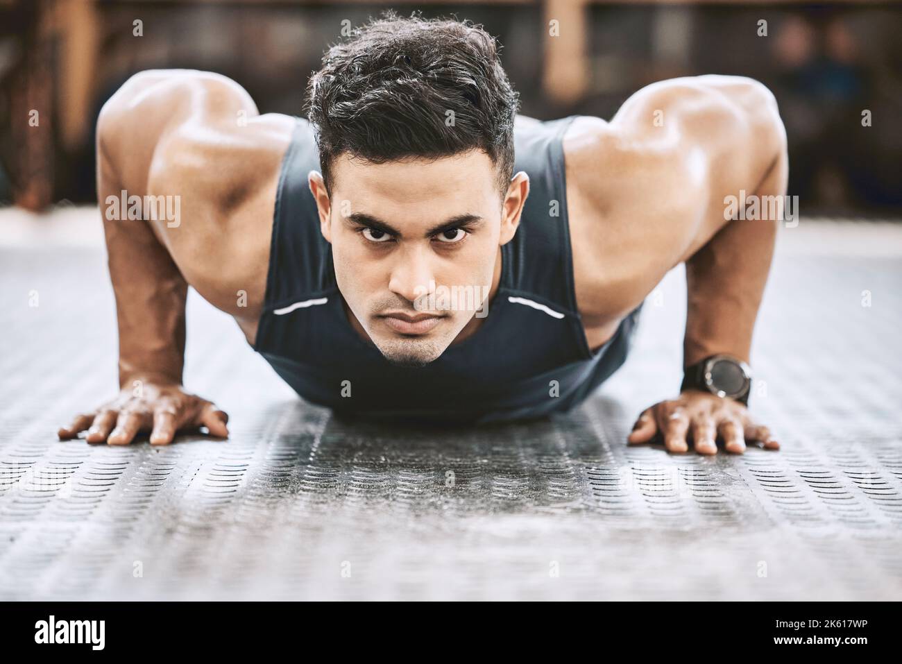 Serious fit man about to do a pushup. Young strong trainer working out ...