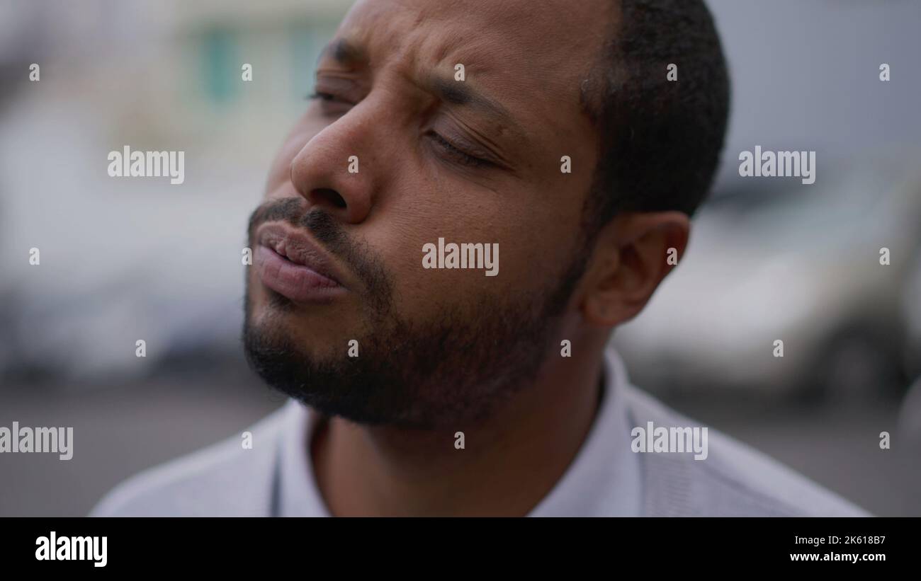 One anxious young African American man in distress closeup face ...