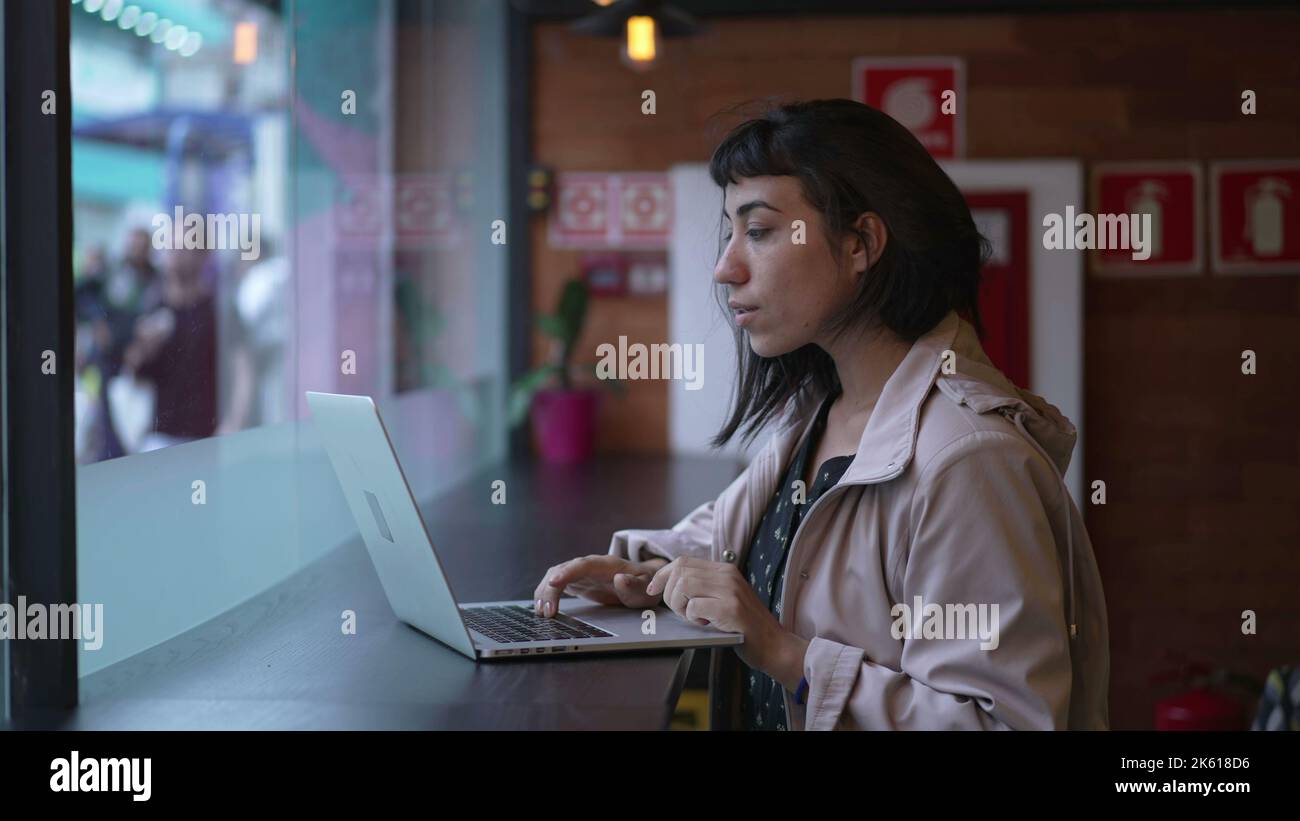 One hispanic young woman opening laptop browsing internet at remote ...