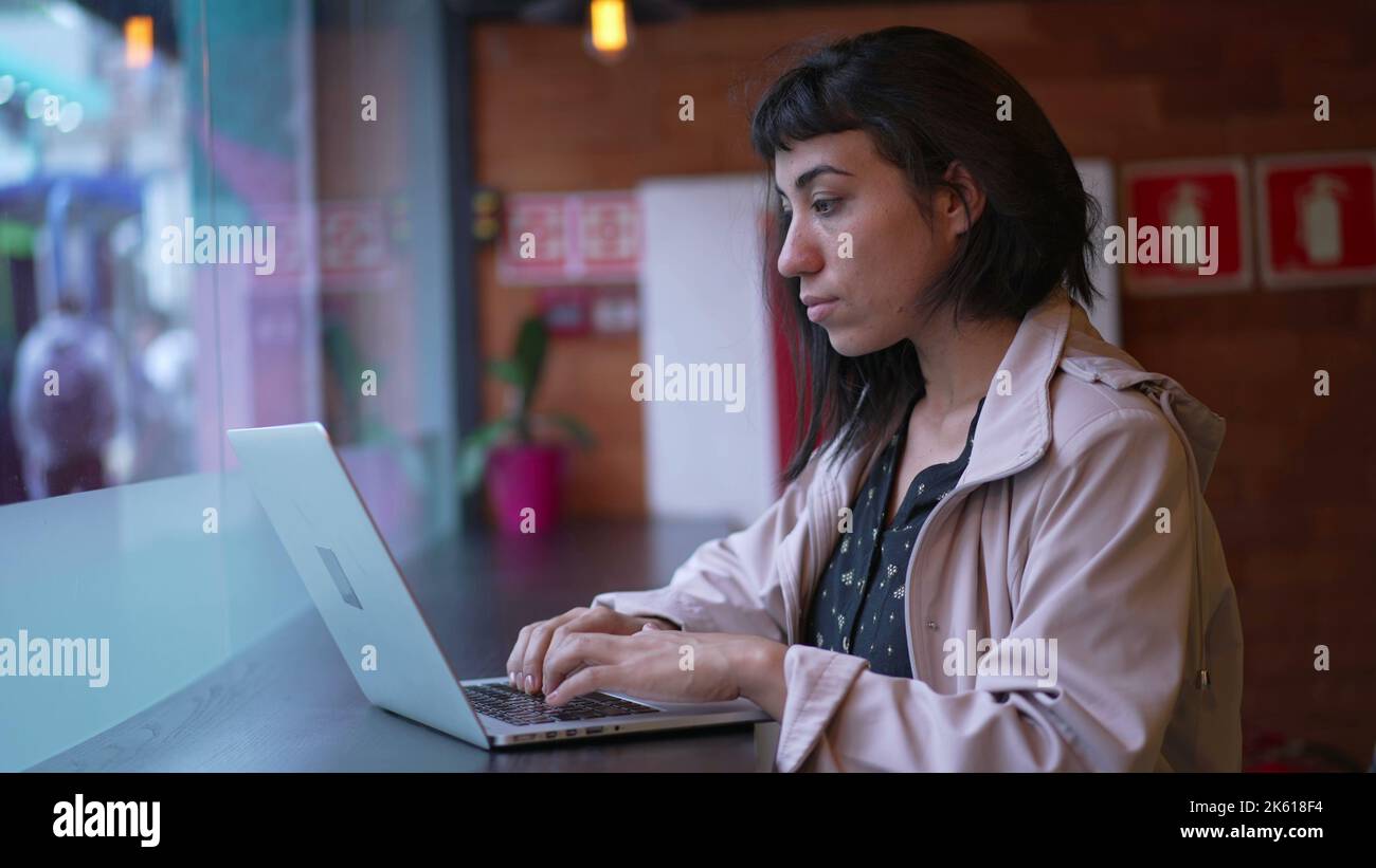 One hispanic young woman working remotely in front of laptop computer ...