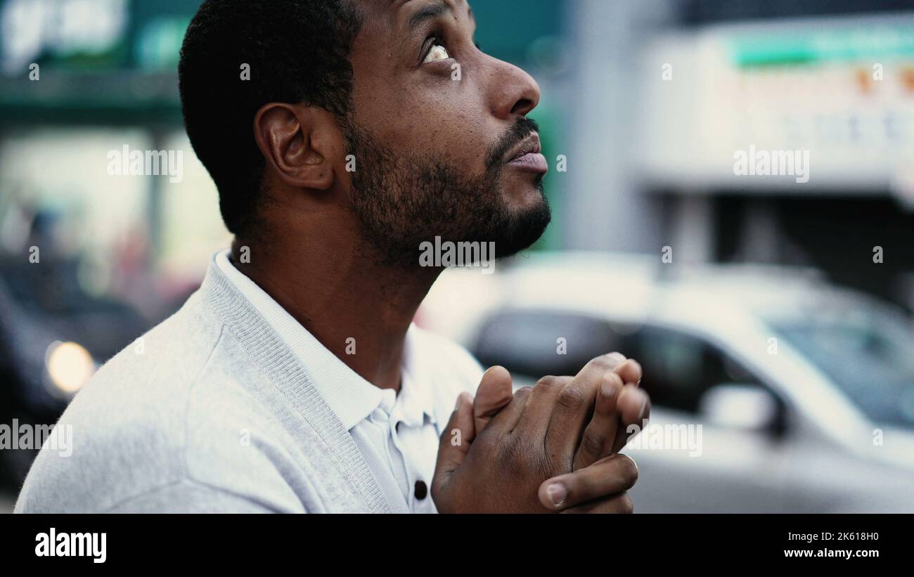 One spiritual young black man praying in street having HOPE and FAITH ...