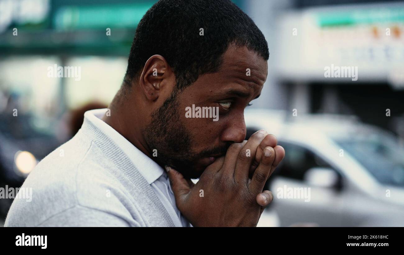 One spiritual young black man praying in street having HOPE and FAITH ...
