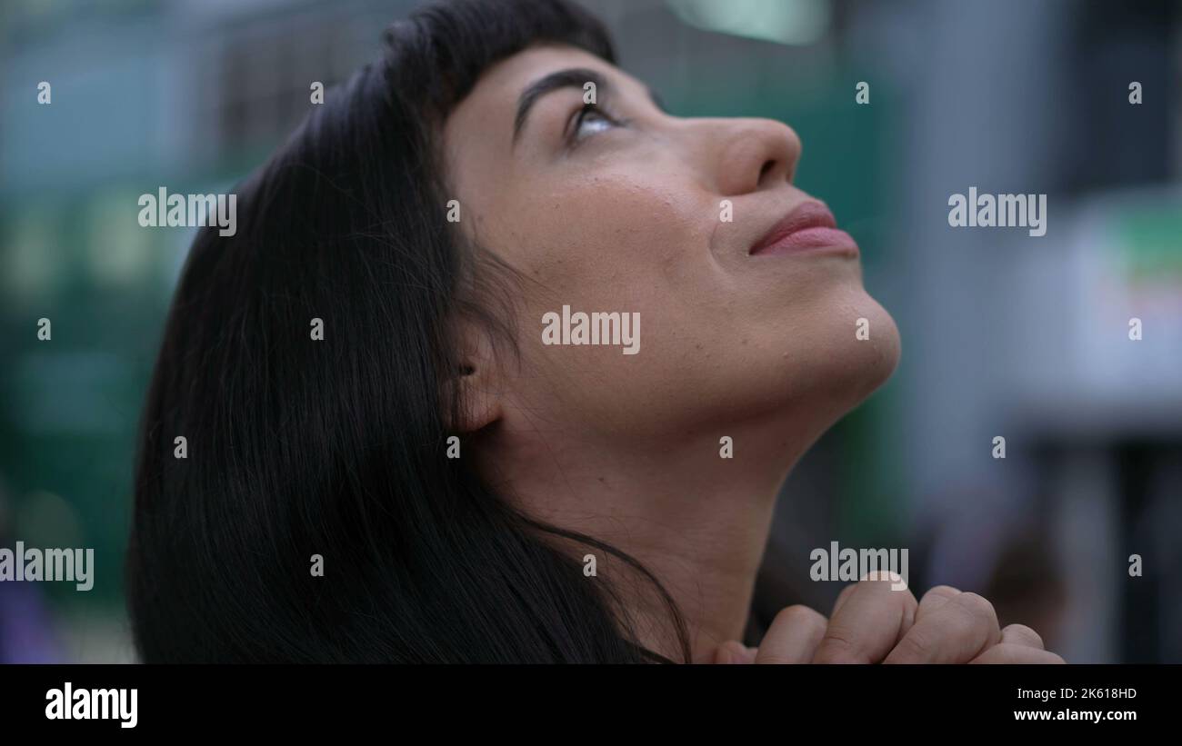 One spiritual young hispanic woman praying to God. Person closing eyes ...