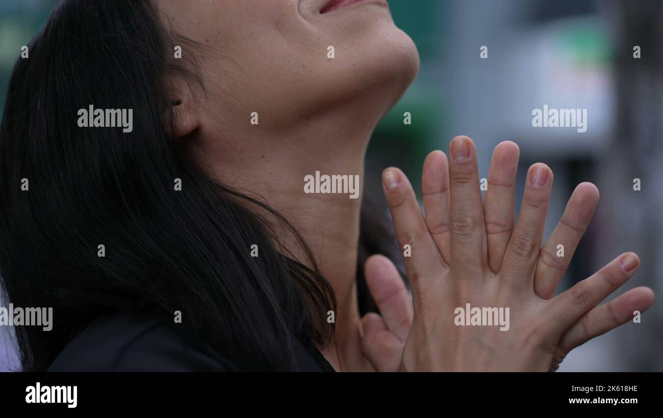 One spiritual young hispanic woman praying to God. Person closing eyes ...