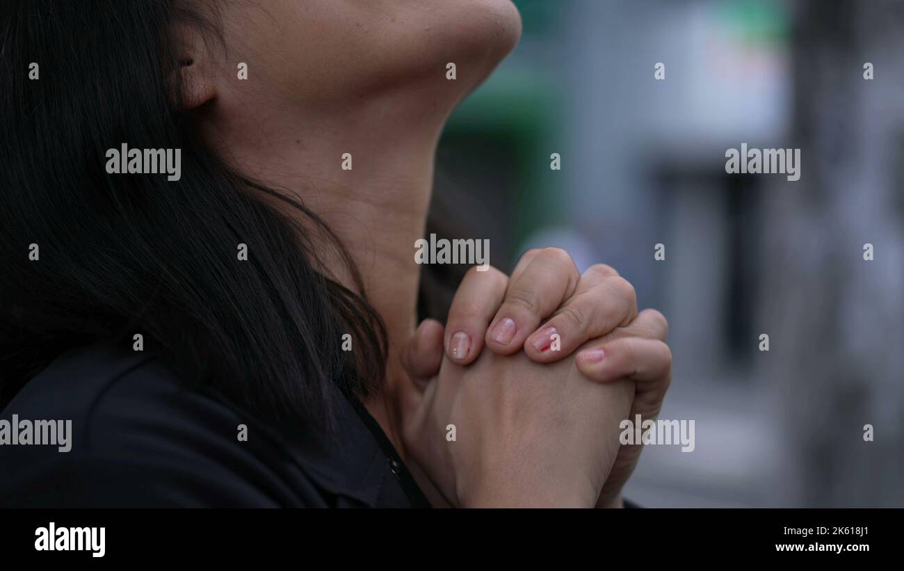 One spiritual young hispanic woman praying to God. Person closing eyes ...