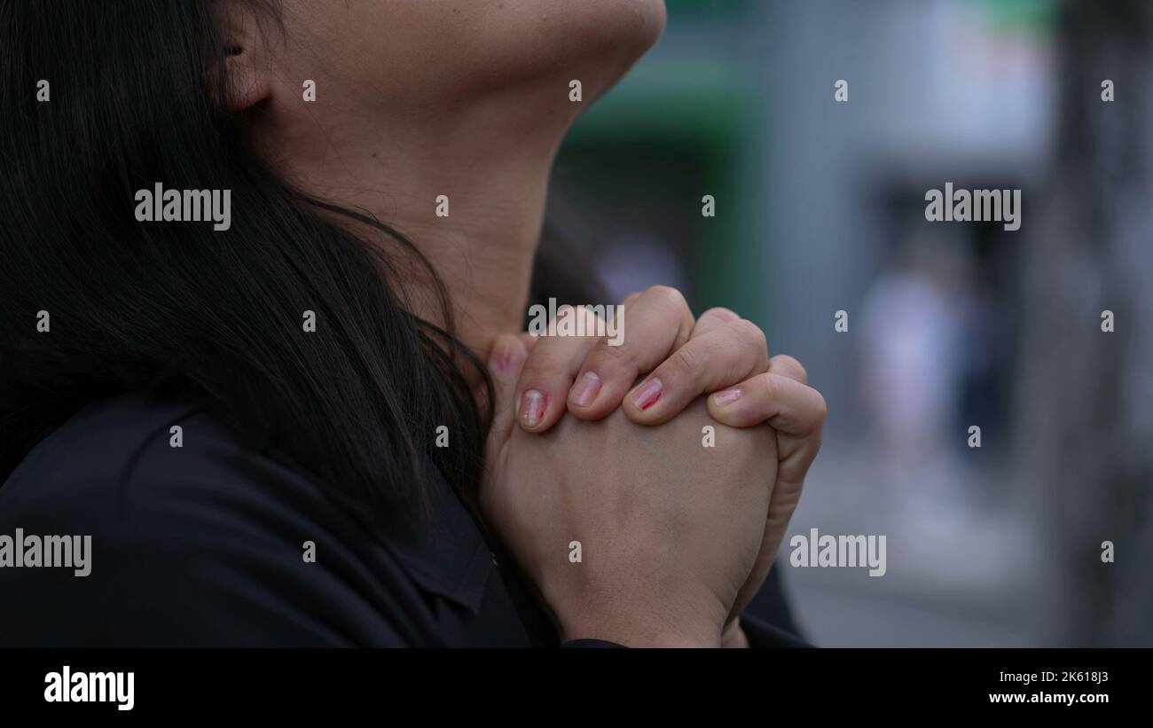 One spiritual young hispanic woman praying to God. Person closing eyes ...