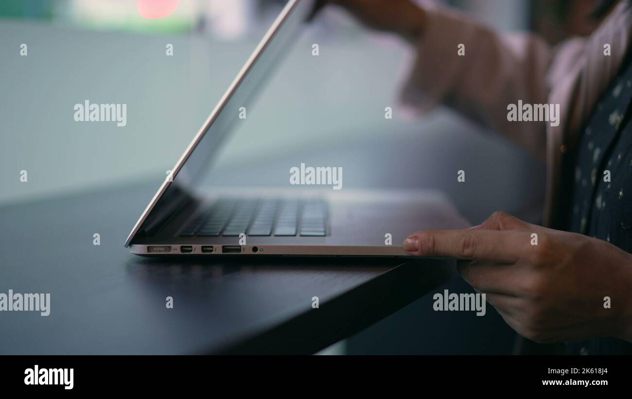 One young hispanic woman opening laptop in coffee shop remote workplace ...