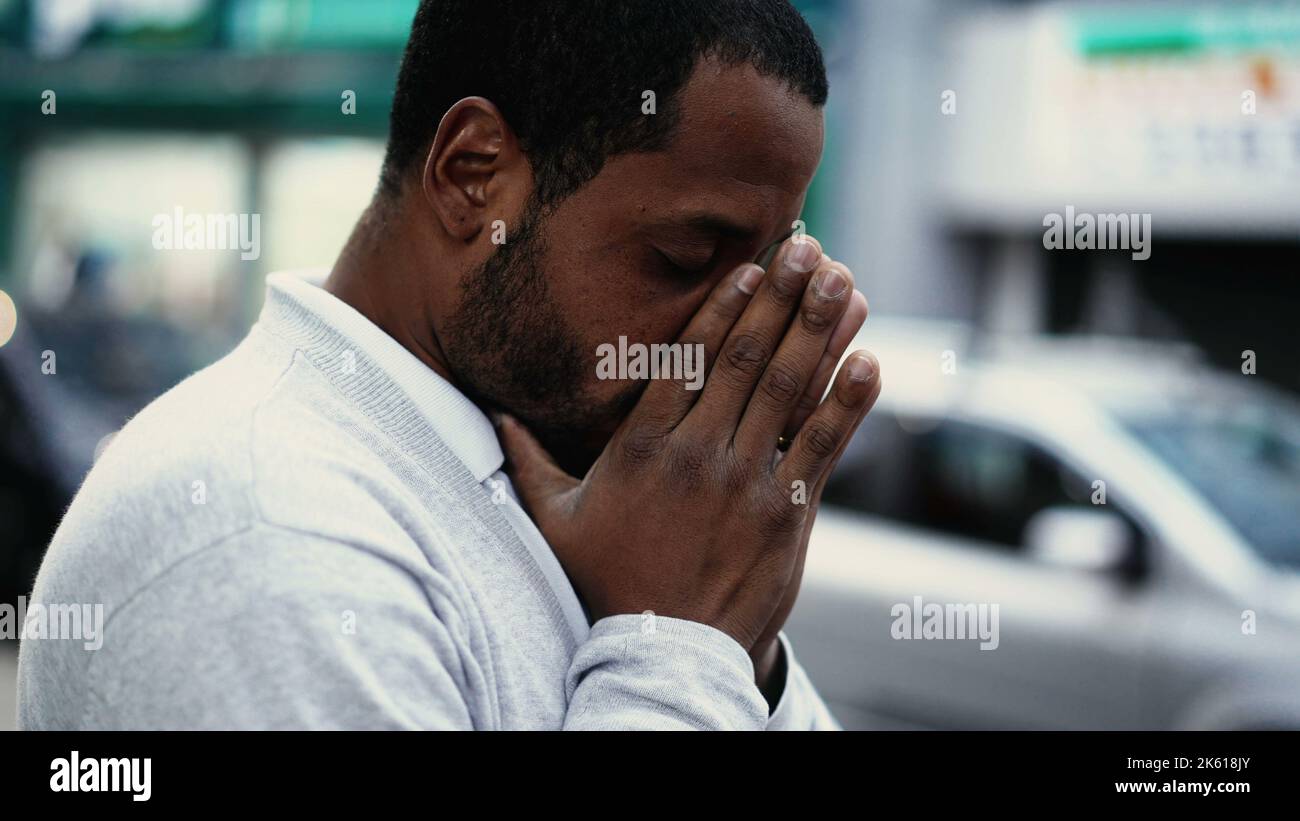 One spiritual young black man praying in street having HOPE and FAITH ...