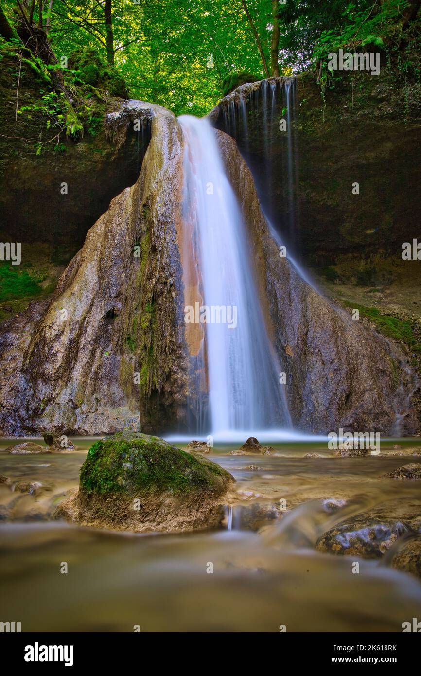 A beautiful scenery of waterfall flowing downstream in a forest Stock ...