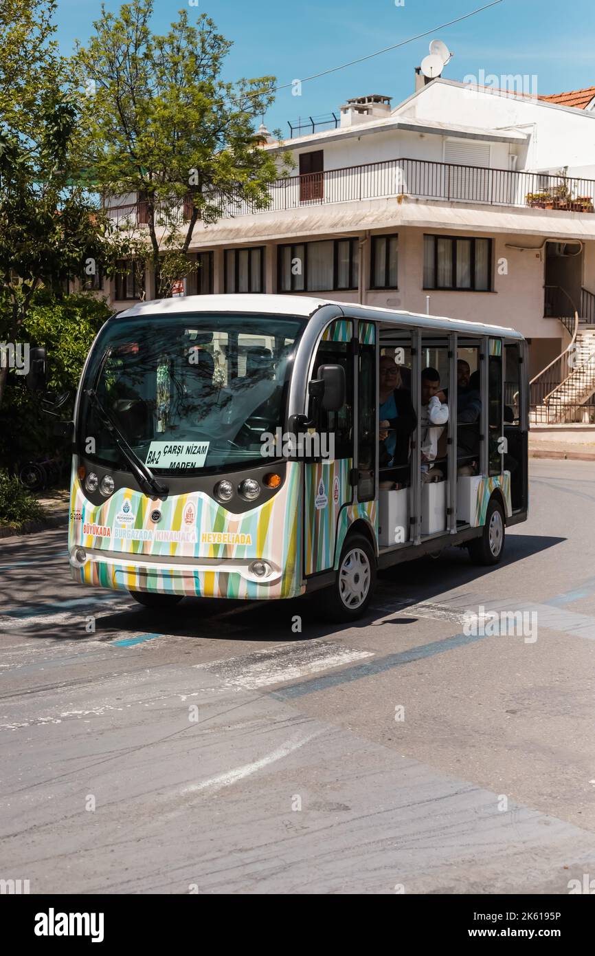 ISTANBUL, TURKEY - MAY 8, 2022: people in public bus passing building ...