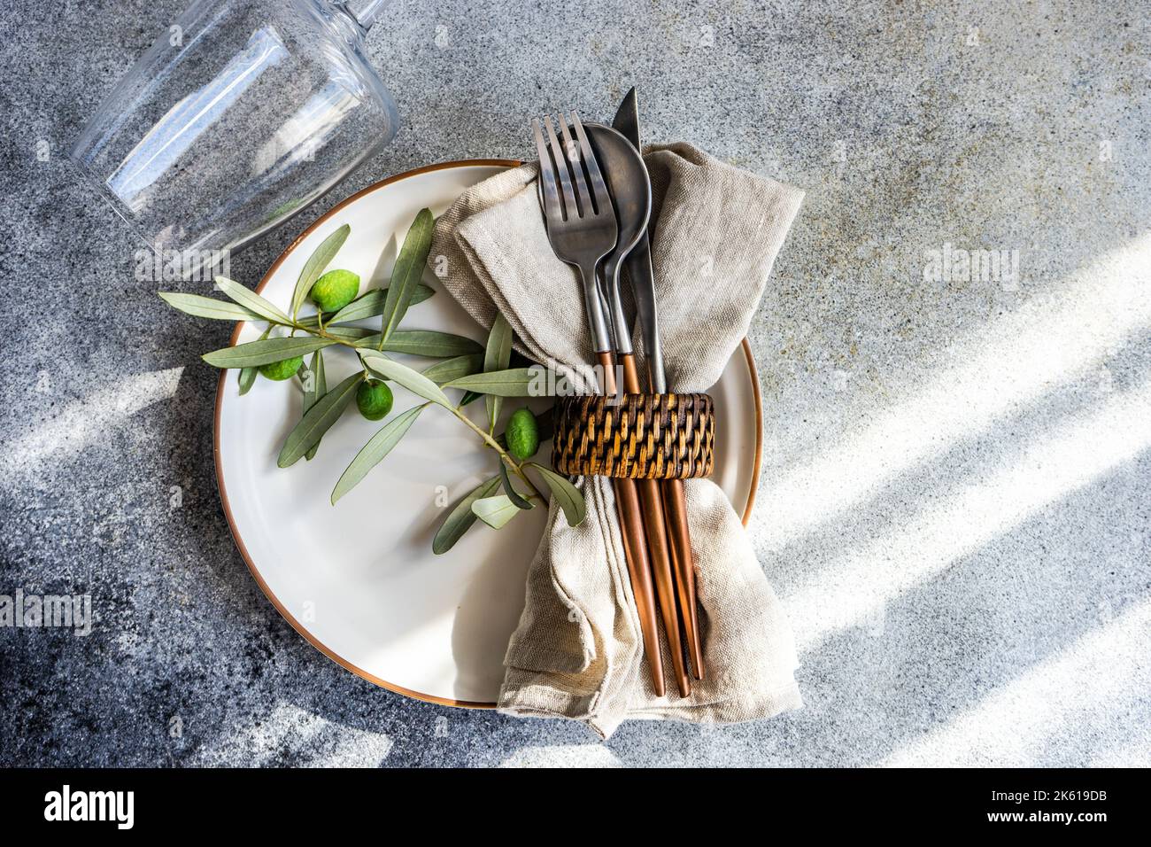 Rustic summer table setting with plate and cutlery decorated with Olive ...
