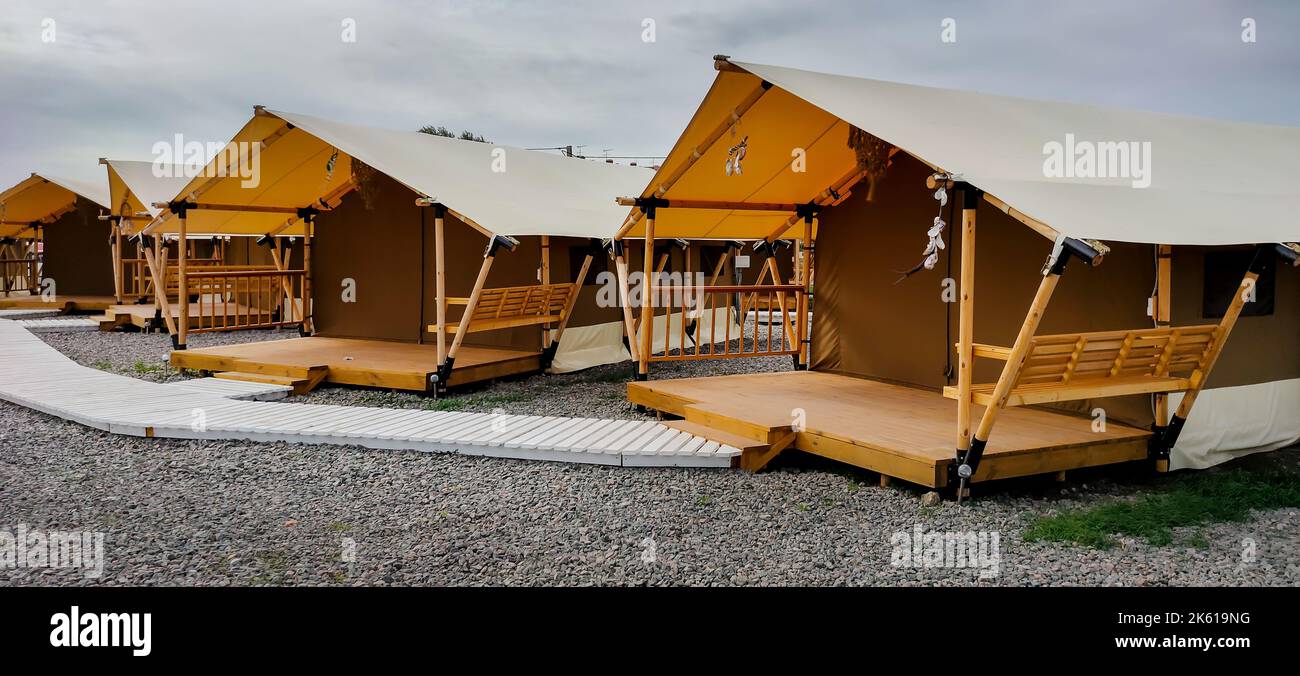 Large wooden framed tents with wooden walkways in a campground Stock ...